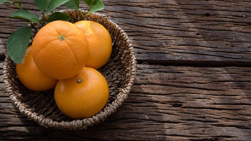 Basket of Orange Fruit Set on Wood Table Stock Image - Image of sweet ...
