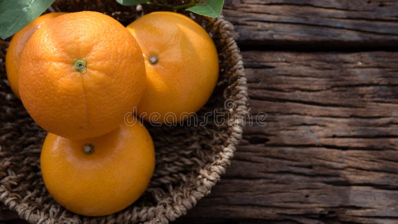 Basket of Orange Fruit Set on Wood Table Stock Image - Image of basket ...