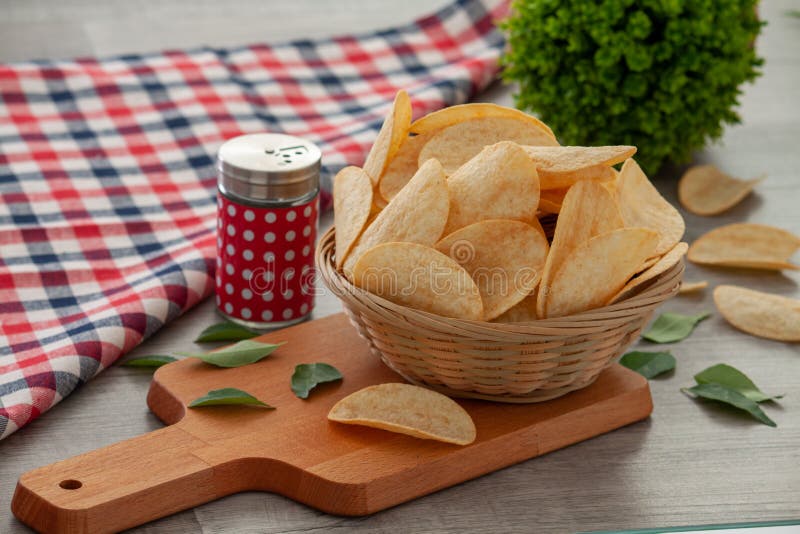A Basket of Potato Chip on Chopping Board Stock Image - Image of spicy ...