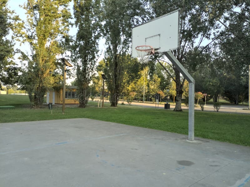 Basketball Court and Hoop in a Park at Sunset Stock Image - Image of ...