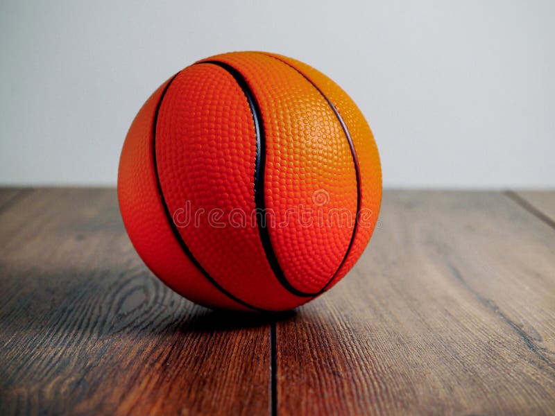 Basketball on a Dark Wooden Floor. Light Grey Background Stock Image ...