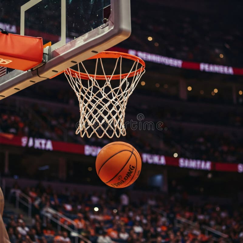 Basketball Falling through Hoop during Professional Game in Arena Stock ...