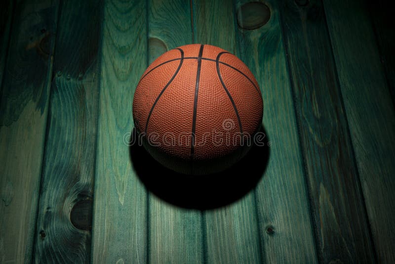 Basketball Isolated on Green Wood Table with Light from Top Stock Photo ...
