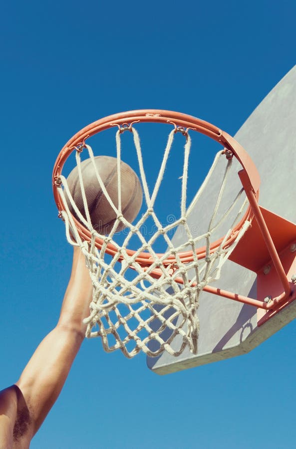 Man about To Slam Dunk Ball on Basketball Court with Strong Sun Shining ...