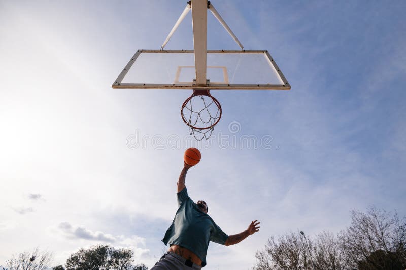 Basketball Player Scoring a Basket Outdoors in a Sunny Day Stock Photo ...