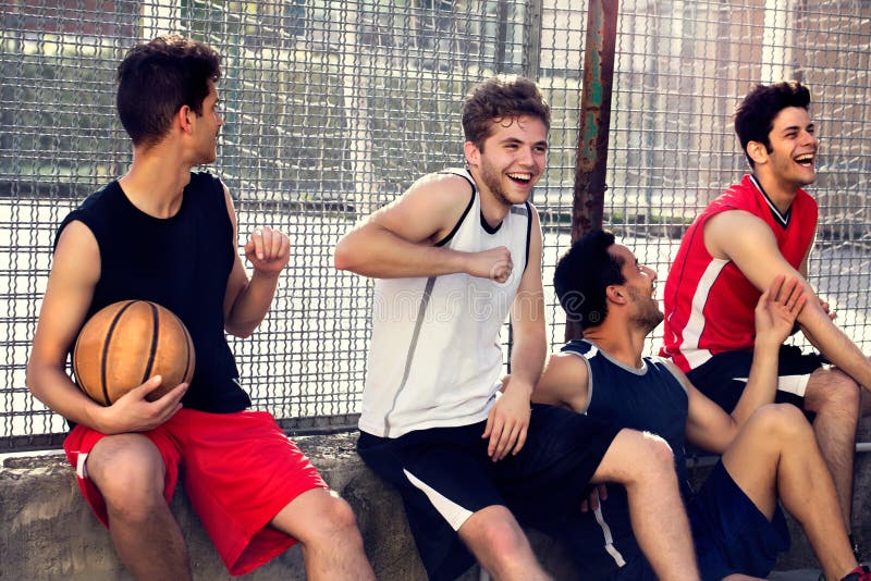 Basketball Players Take a Break Sitting on a Low Wall Stock Photo ...