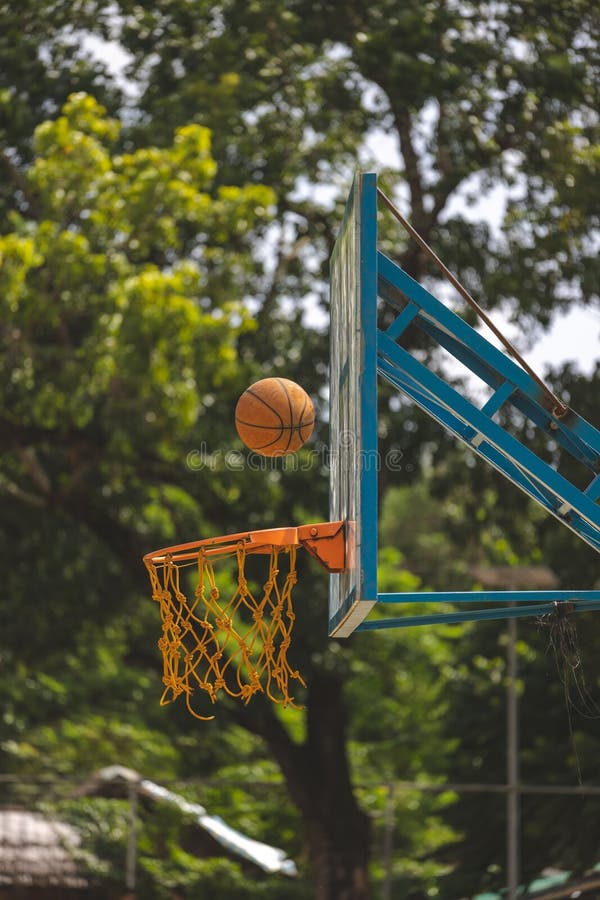 Basketball in the Process of Falling into the Hoop Stock Photo - Image ...