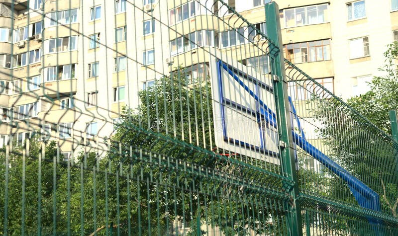 A Basketball Shield on a Street Court is Viewed from Behind through a ...