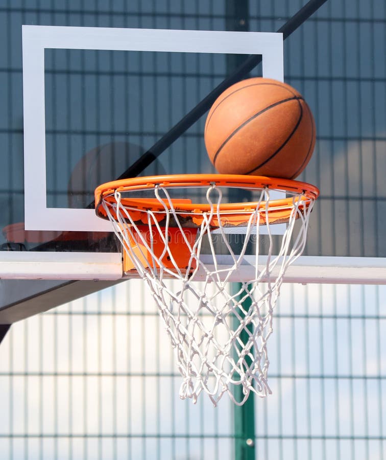 A Basketball is Sitting on Top of a Basketball Net Stock Photo - Image ...