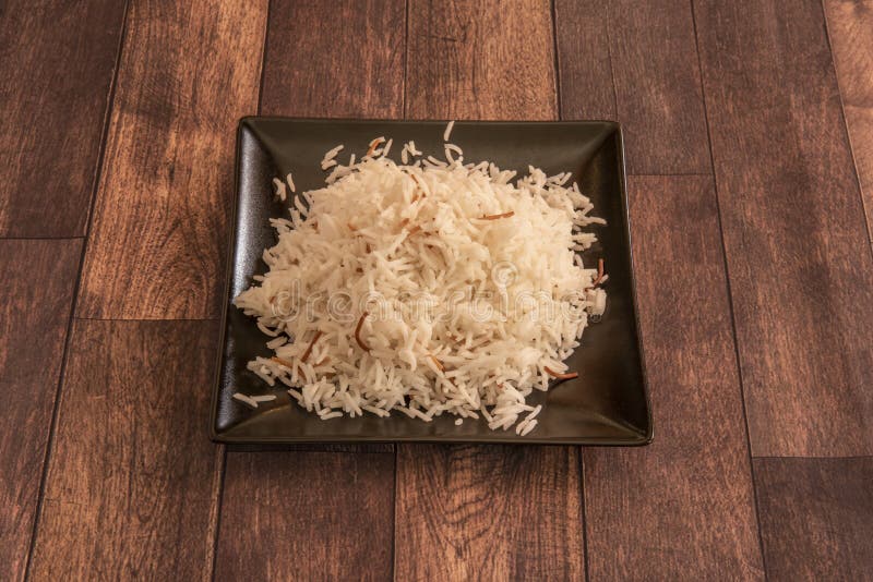 Basmati Rice Serving on a Small Square Black Plate on a Wooden Table ...