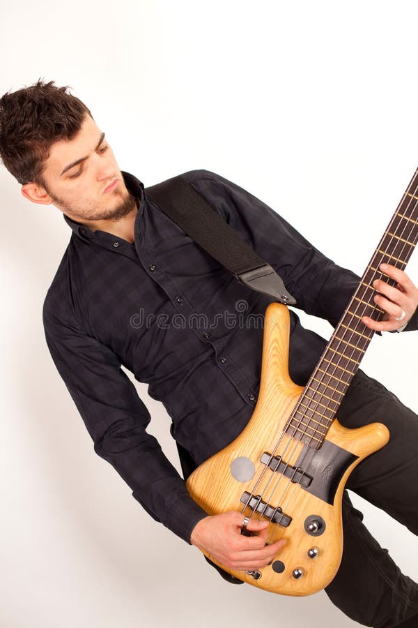 Bass Player Looking at His Instrument Stock Photo - Image of hair ...