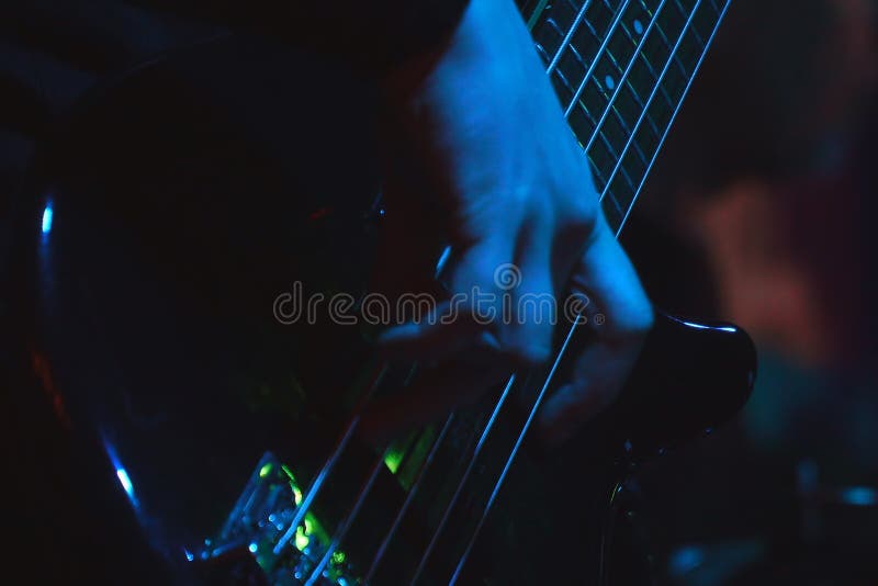 The Bass Player Plays a Five-string Bass Guitar Stock Photo - Image of ...