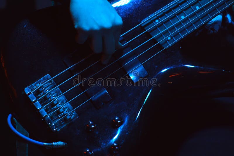 The Bass Player Plays a Five-string Bass Guitar Stock Photo - Image of ...