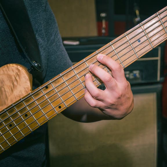The Bass Player Plays a Five-string Bass Guitar Close-up Stock Image ...