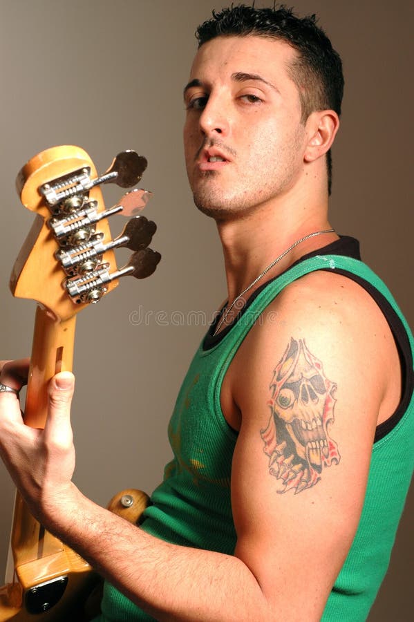 Bass player with tattoo stock photo. Image of happy, design - 488872