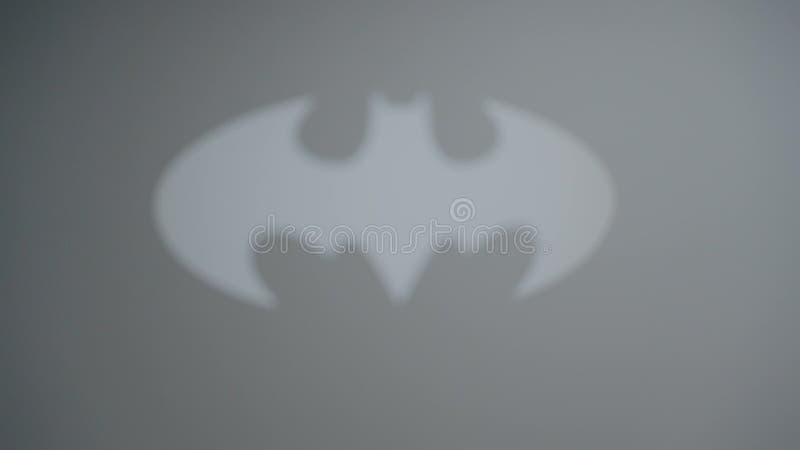 Bat Symbol Projected on a Wall, Showcasing Iconic Imagery in a Dimly ...
