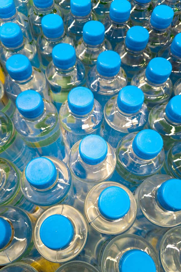 Batch of Water Bottles with Blue Caps Stock Image - Image of bright ...