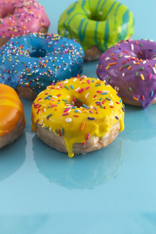 Batch of Rainbow Colored Glazed Donuts Stock Photo - Image of food ...