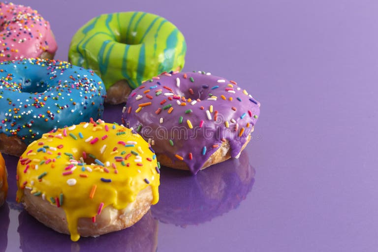 Batch of Rainbow Colored Glazed Donuts Stock Image - Image of donut ...