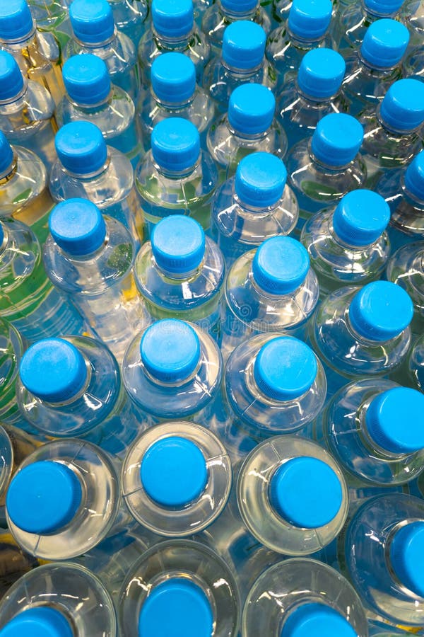 Batch of Water Bottles with Blue Caps Stock Image - Image of batch ...