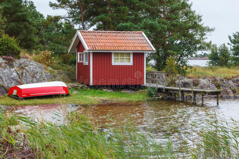 Bath Cabin at a Beach with a Rowing Boat and a Jetty Stock Photo ...