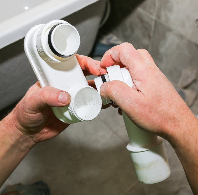 Bath Installation. Worker is Making Drain with Hose Tube. Maintenance ...