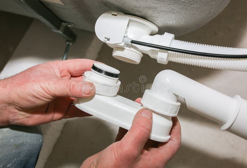 Bath Installation. Worker is Making Drain with Hose Tube. Maintenance ...