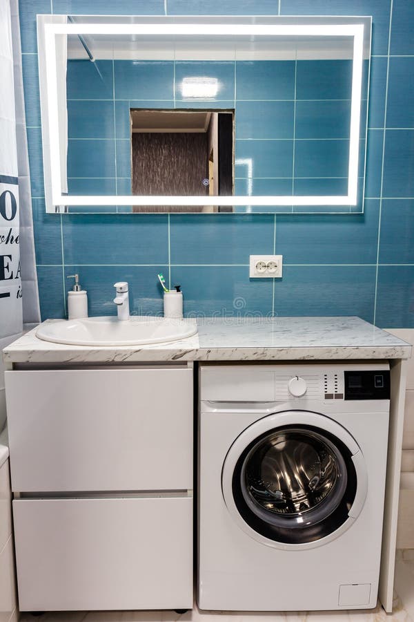 Bathroom with Countertop Sink, Large Mirror and Washing Machine Stock ...