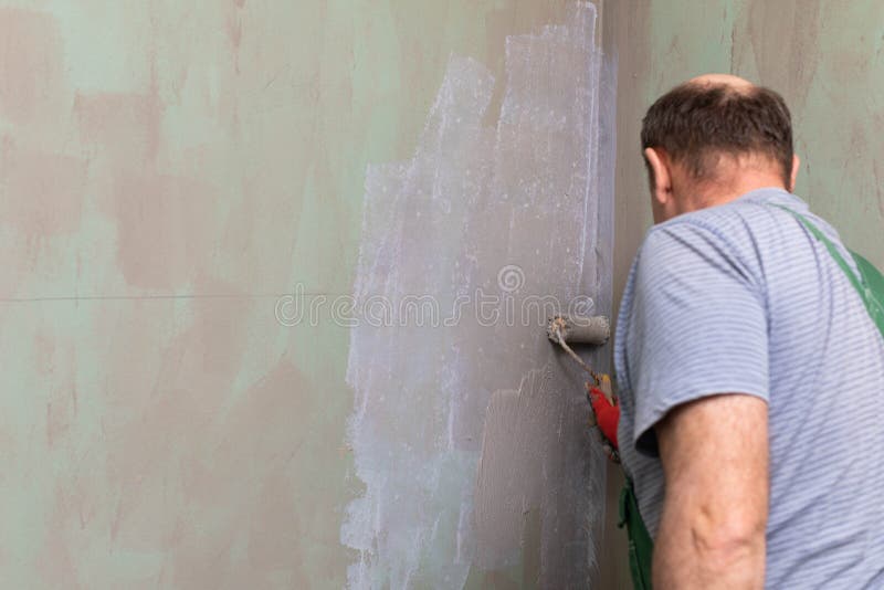 In the Bathroom, a General Construction Worker Applies Moisture ...