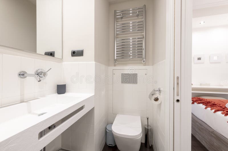 Bathroom with Unusually Designed Sink, Chrome Taps and Heated Towel ...
