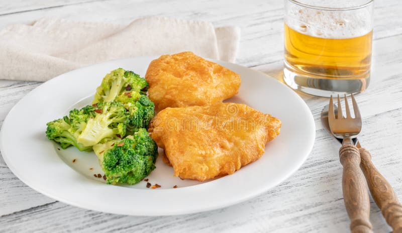 Battered Fish with Broccoli Stock Photo - Image of glass, knife: 186273760