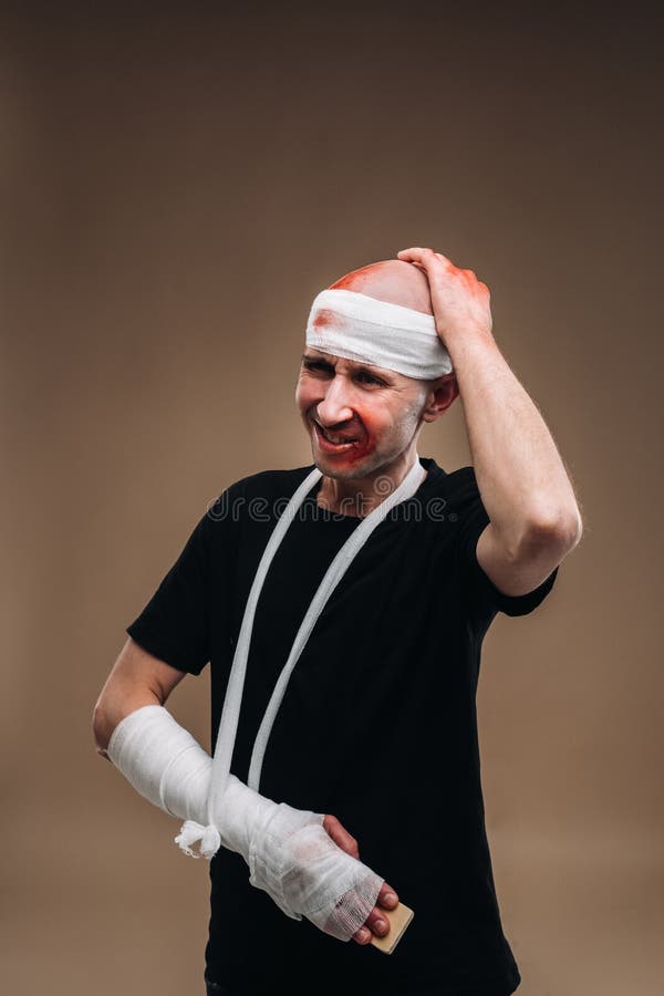 Battered Man Bandaged Head Cast His Arm Stands Gray Background Stock ...
