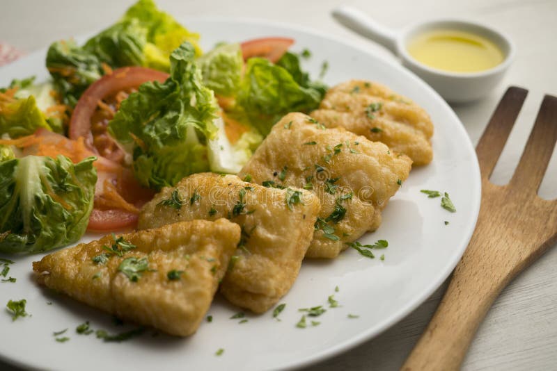 Battered White Fish Served with a Tomato Salad. Stock Image - Image of ...