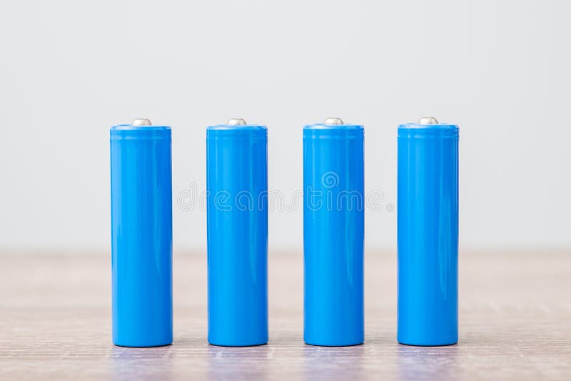 4 Batteries Standing on the Table Stock Image - Image of power, storage ...