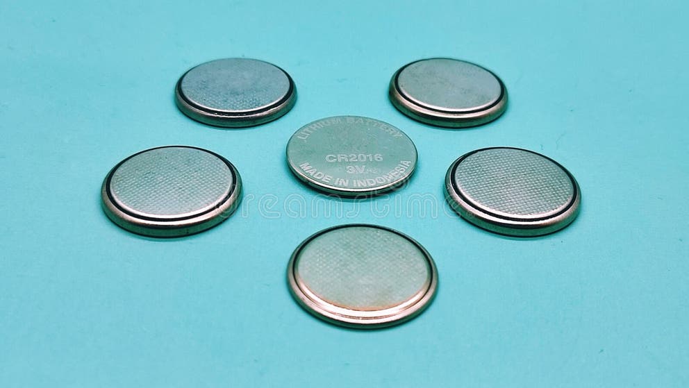 Battery Button Cells with Green Background Stock Photo - Image of ...