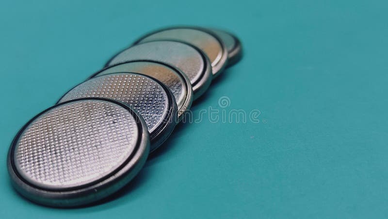 Battery Button Cells with Green Background Stock Photo - Image of ...