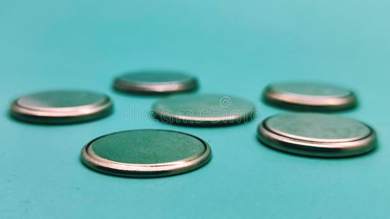 Battery Button Cells with Green Background Stock Photo - Image of azure ...