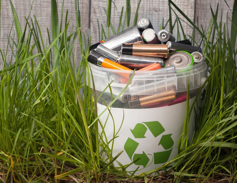 Battery Recycle Bin with Old Element on Wood Table in Grass Stock Photo ...