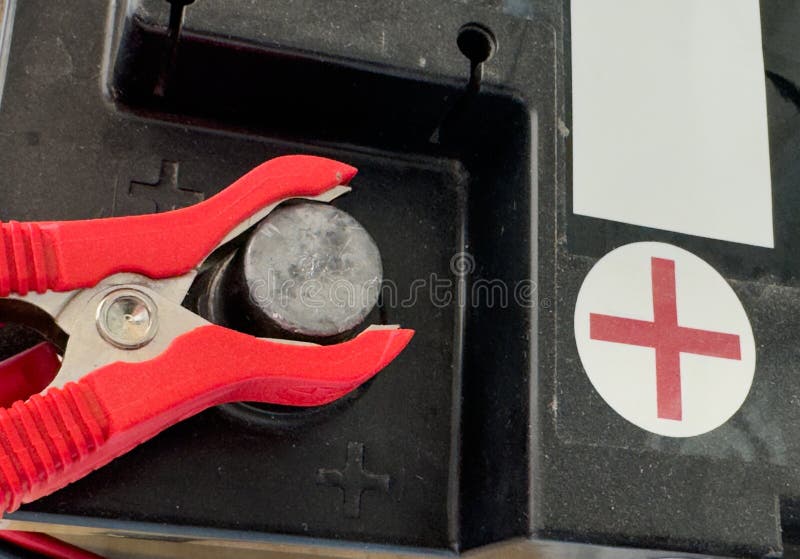 A Battery Terminal with a Red Clamp Connected To the Positive Contact ...