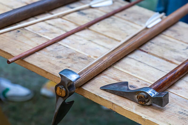 Battle Ax with a Long Handle and a Heavy Sharp Blade Lying on the Table ...