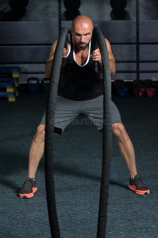 Battling Ropes Young Man at Gym Workout Exercise Stock Photo - Image of ...