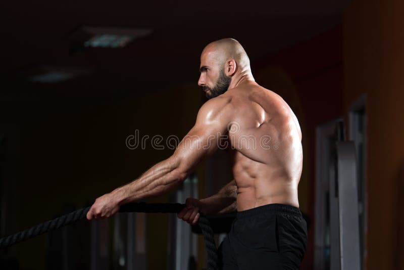Battling Ropes Young Man at Gym Workout Exercise Stock Photo - Image of ...