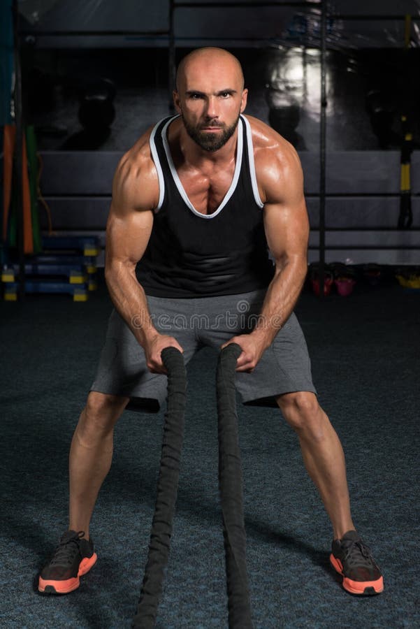 Battling Ropes Young Man at Gym Workout Exercise Stock Image - Image of ...