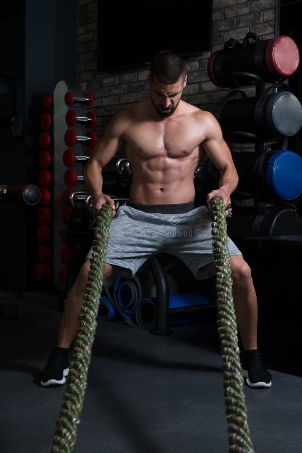 Young Man Battling Ropes at Gym Workout Exercise Stock Photo - Image of ...