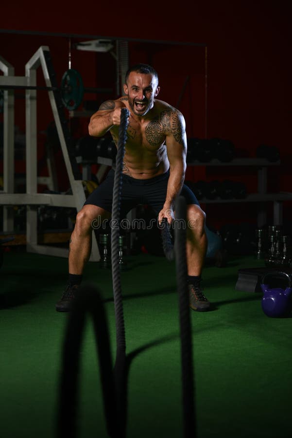 Young Man Battling Ropes at Gym Workout Exercise Stock Photo - Image of ...