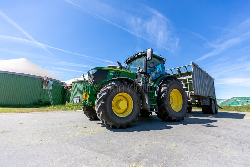 John Deere Tractor with a Loader Wagon, Working on a Biogas Plant ...