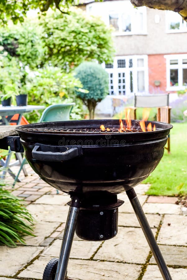 Bbq Grill with Flames in an Empty Back Garden Preparing To Cook Outside ...