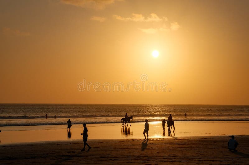 A Beach Abuzz with Life, Bathed in the Glow of Kuta S Orange Twilight ...