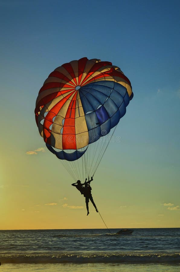 Beach activity in sunset stock photo. Image of beach - 33612874