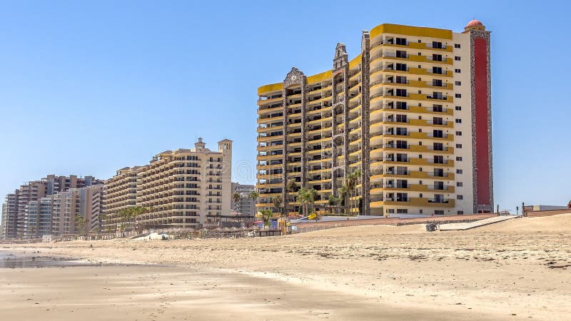 A Beach Area with Two Buildings on Either Side of it Stock Photo ...